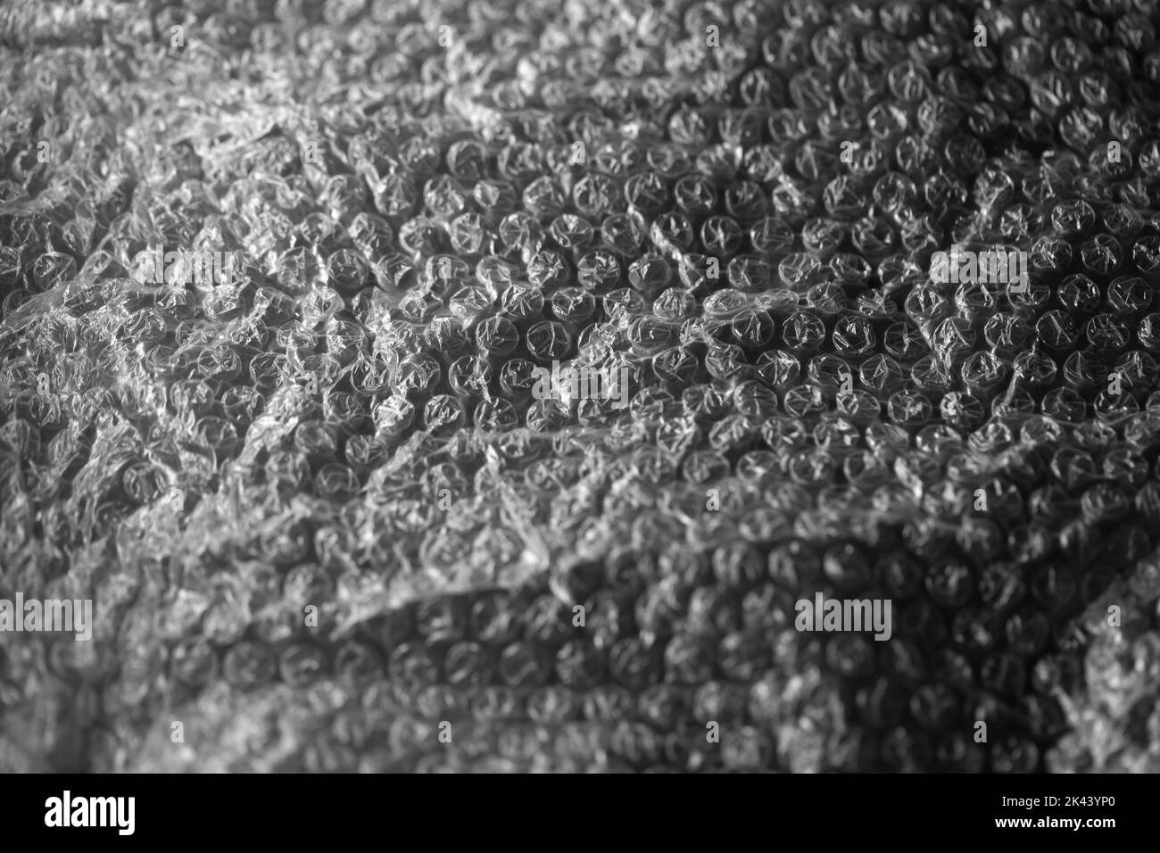 Reflecting light and shadow on creases and folds in plastic bubble wrap ...