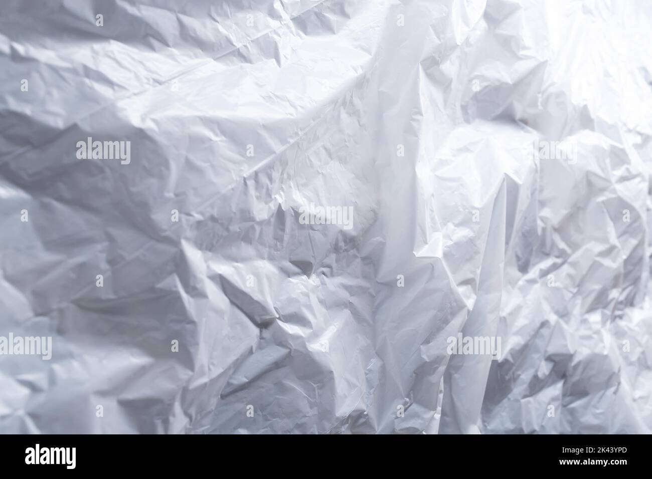 Reflecting light and shadow on creases and folds in scrunched white ...