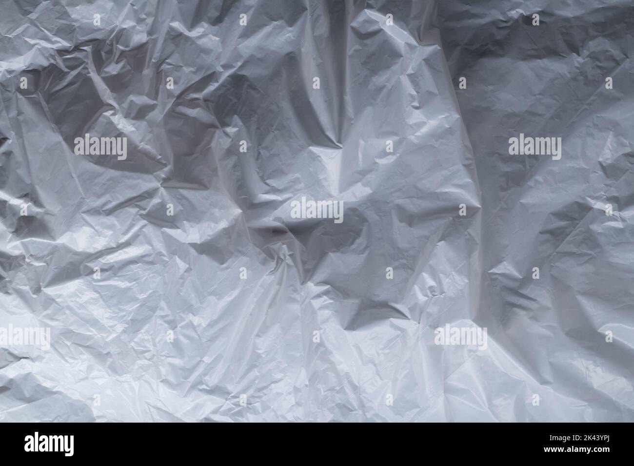 Reflecting light and shadow on creases and folds in scrunched thin ...