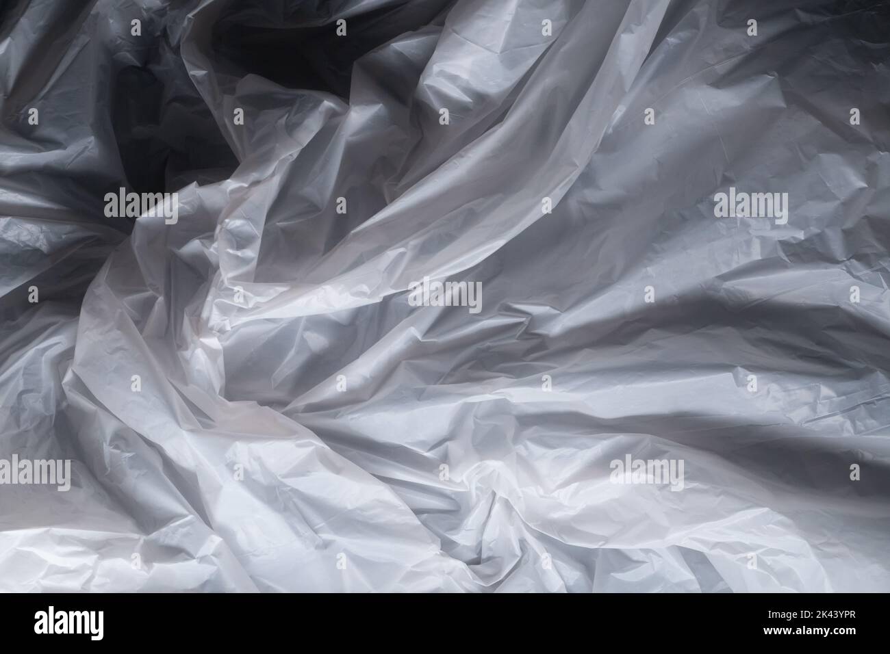 Reflecting light and shadow on creases and folds in scrunched thin ...