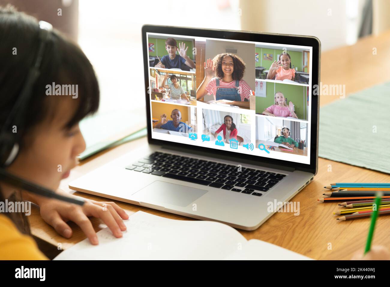 Asian girl using laptop for video call, with diverse elementary school ...