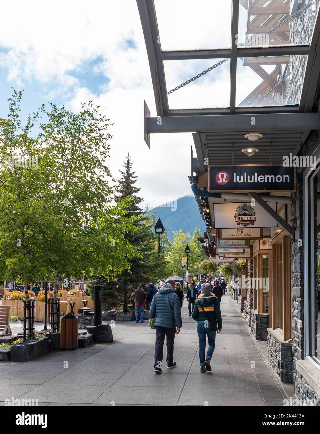 People walking in front of he lululemon store on Banff Avenue in Banff ...