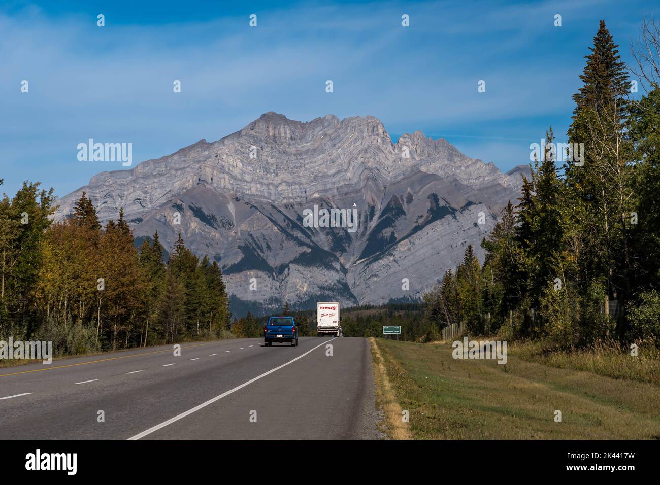 Traffic along the Trans Canadian Highway looking towards a large mountain in Banff, Alberta ...