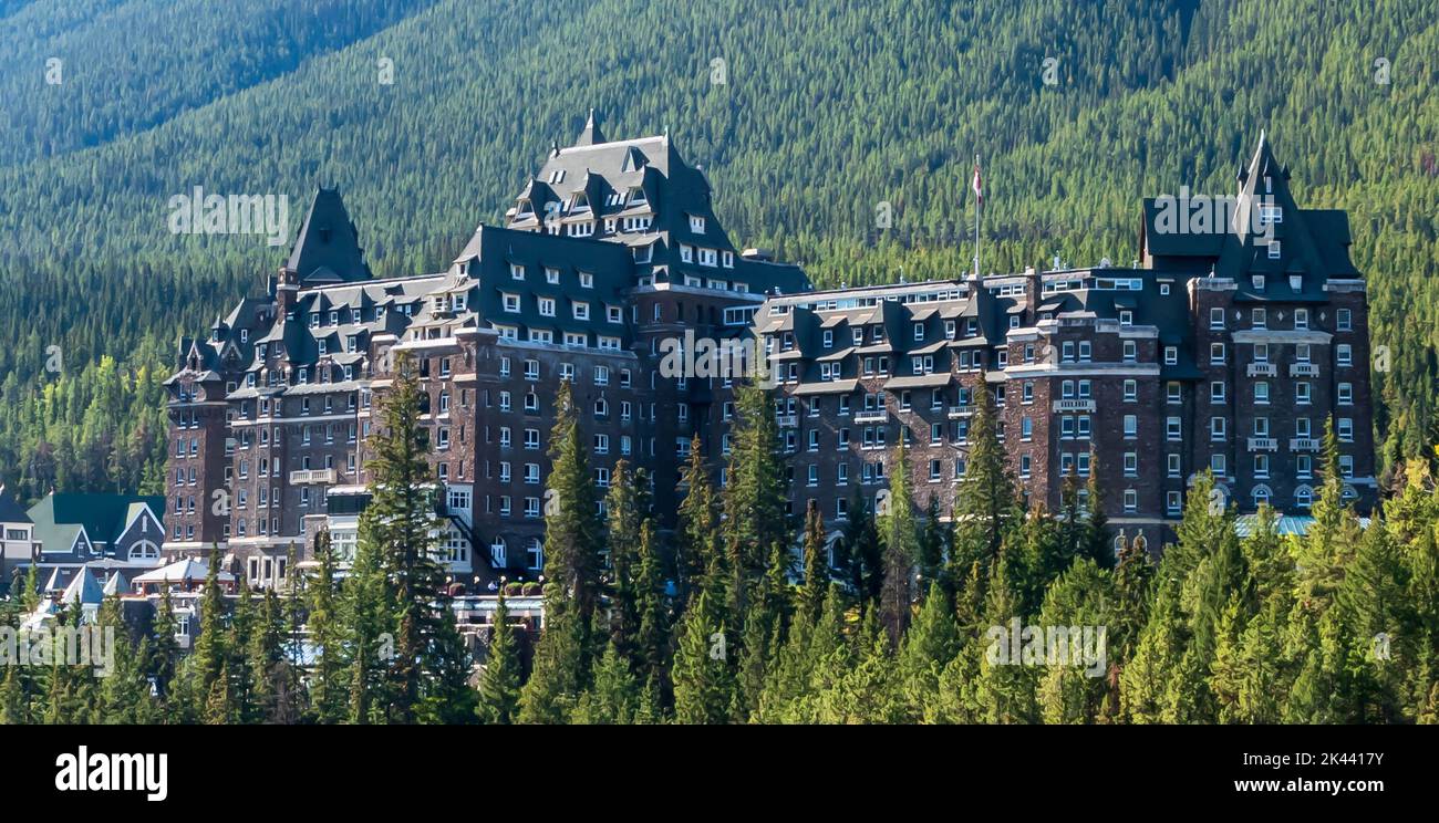 The Fairmont Banff Springs Hotel surrounded by evergreen trees in Banff ...