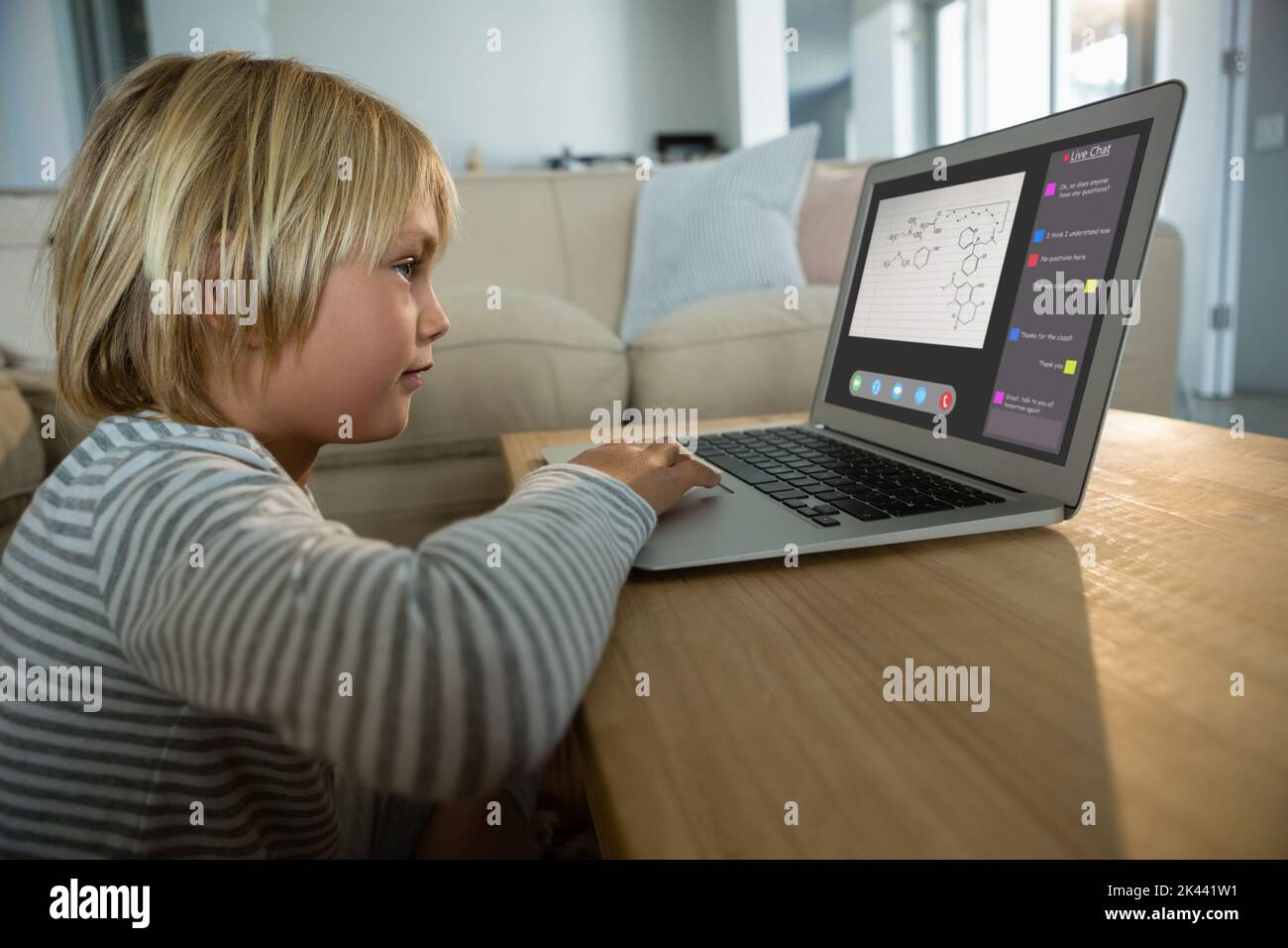 Caucasian boy using laptop for video call, with class on screen ...