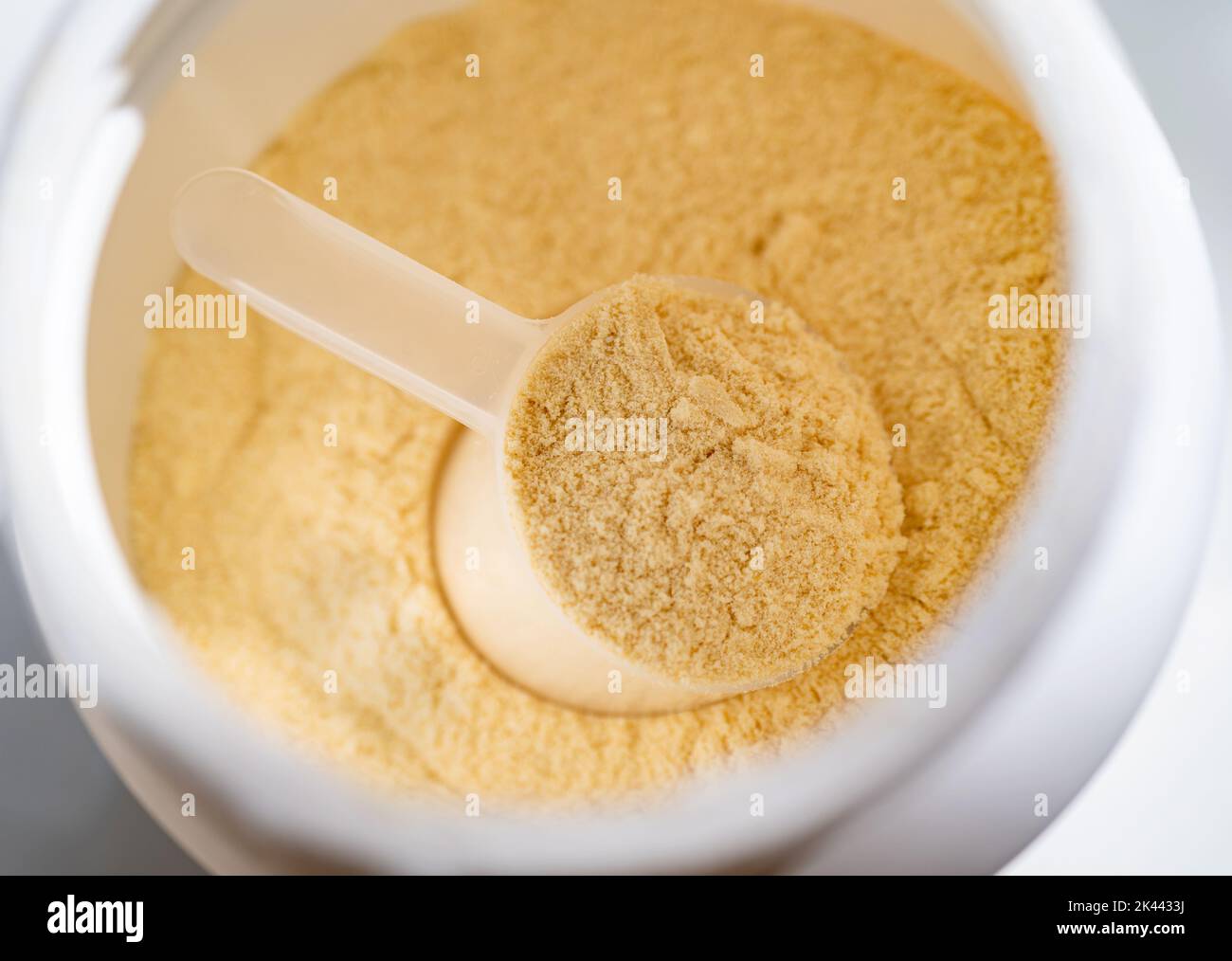 Cup of protein powder in container Stock Photo - Alamy