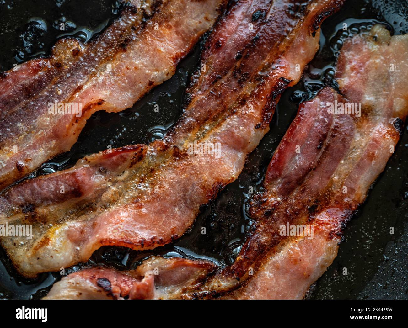 Preparing breakfast frying bacon close hi-res stock photography and ...