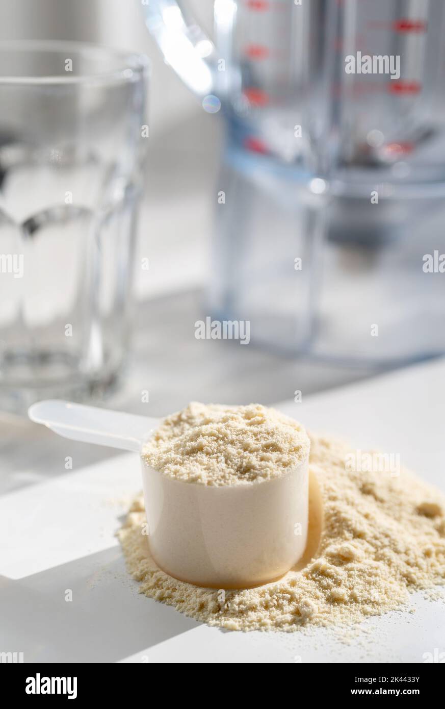 Protein powder in a plastic measuring cup with smoothie glass Stock ...