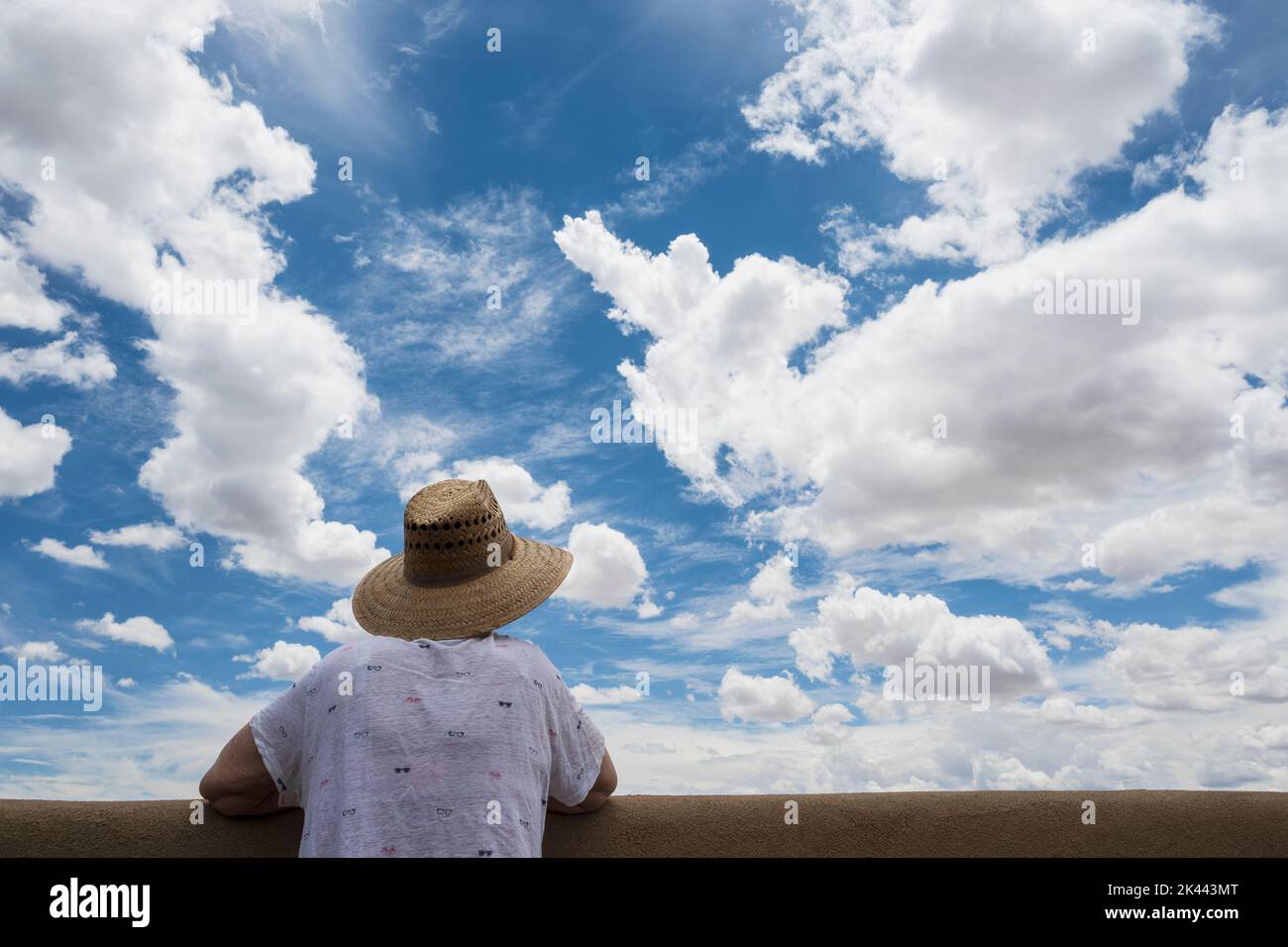 Woman looking over wall hi-res stock photography and images - Alamy