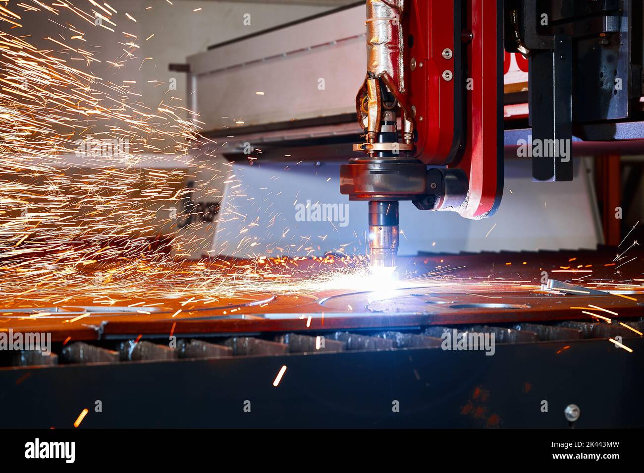 Plasma cutting of metal plate with flying sparks in workshop Stock ...