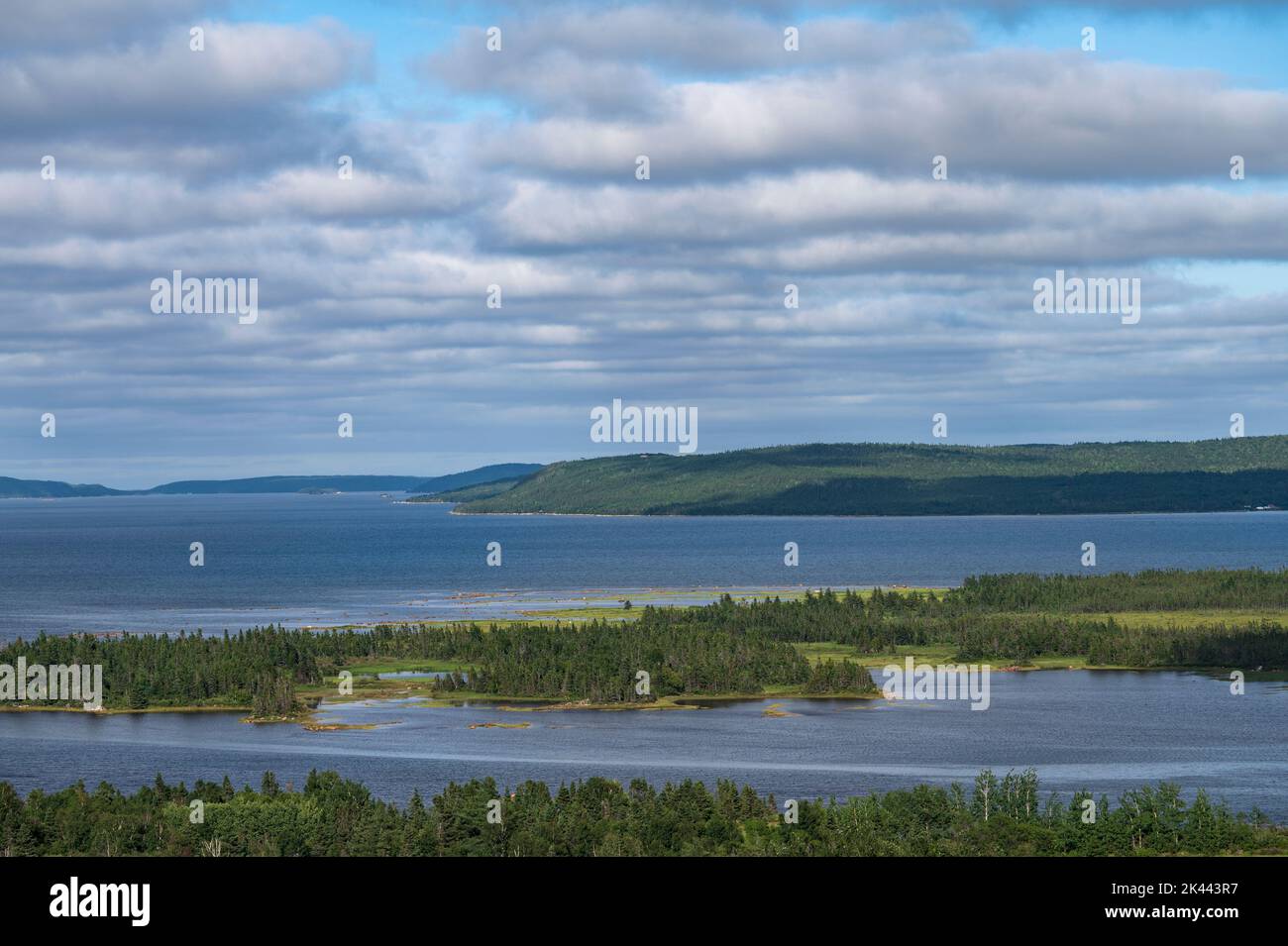 Canada, Newfoundland - Labrador, Lumsden, White puffy clouds over ocean ...