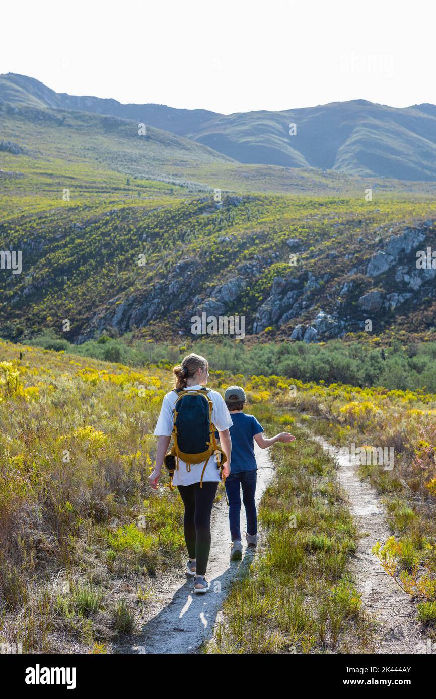 South Africa, Hermanus, Teenage girl (16-17) and brother (8-9) hiking ...
