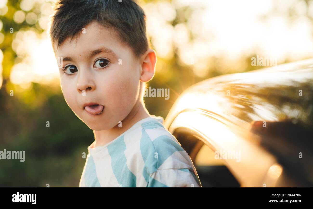 Happy funny little boy, traveling by car enjoying weekend trip with ...