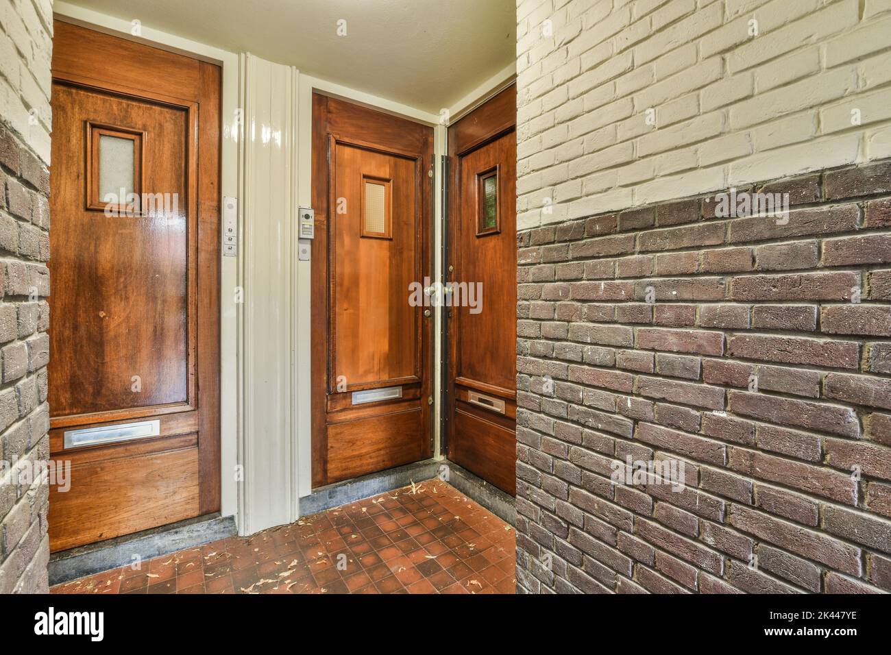 Light narrow hallway with many doors and parquet floor Stock Photo - Alamy