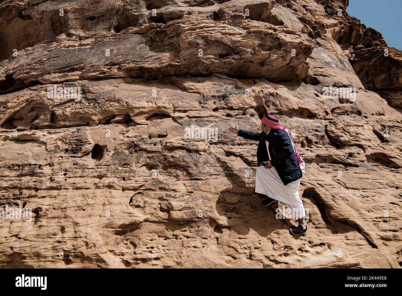 A world authority on Thamudic script pointing out the writing and rock ...