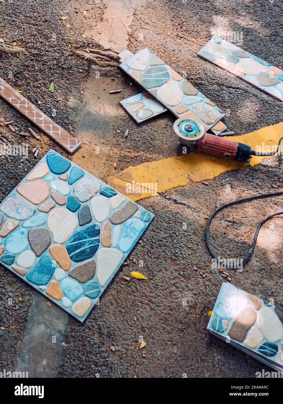 Old Red Angle Grinder With Rotary Blade On Aluminum Surface With Tiles On Floor Electric Angle