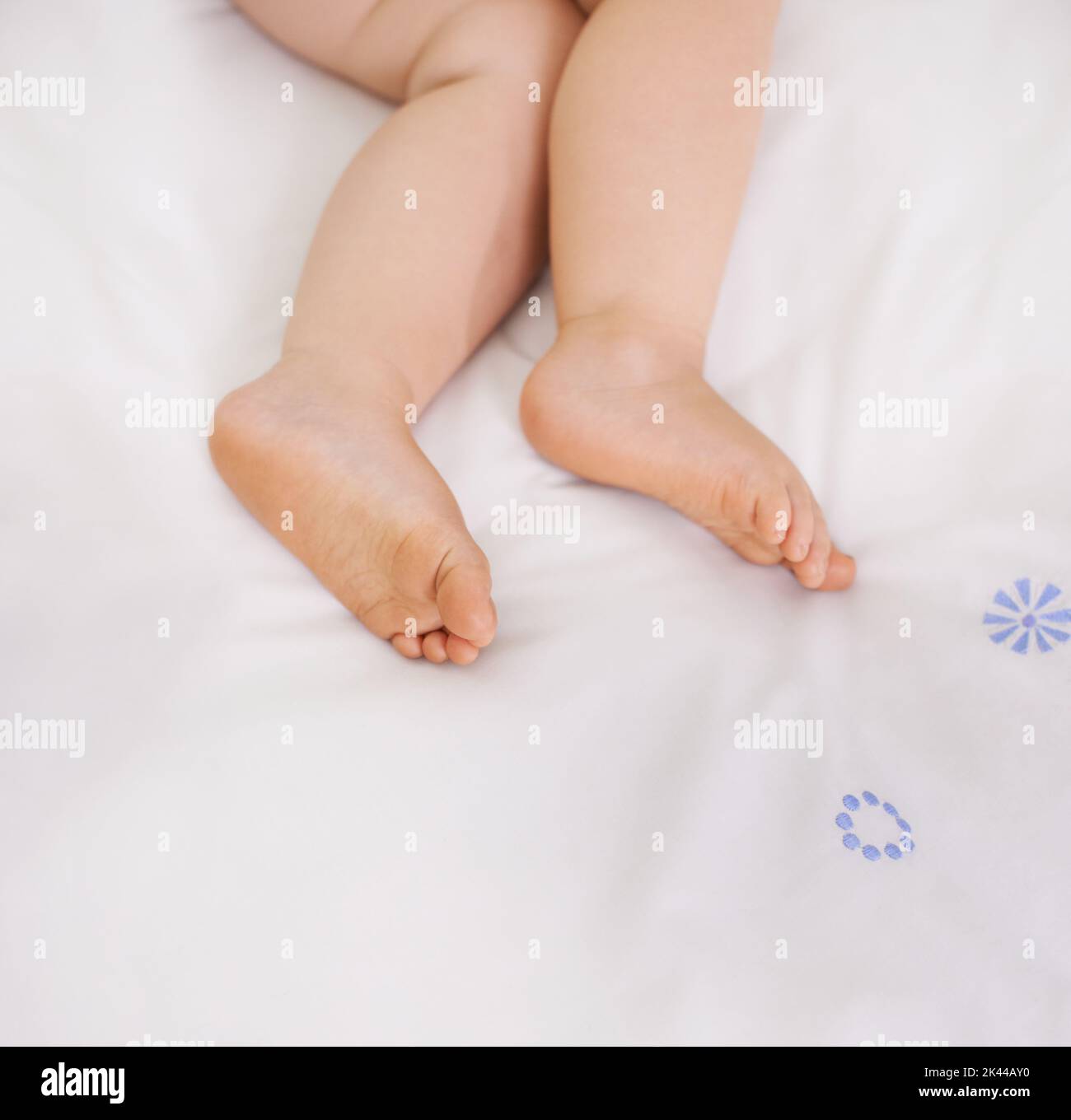 The picture of innocence. A cropped image of a babys legs lying on a ...