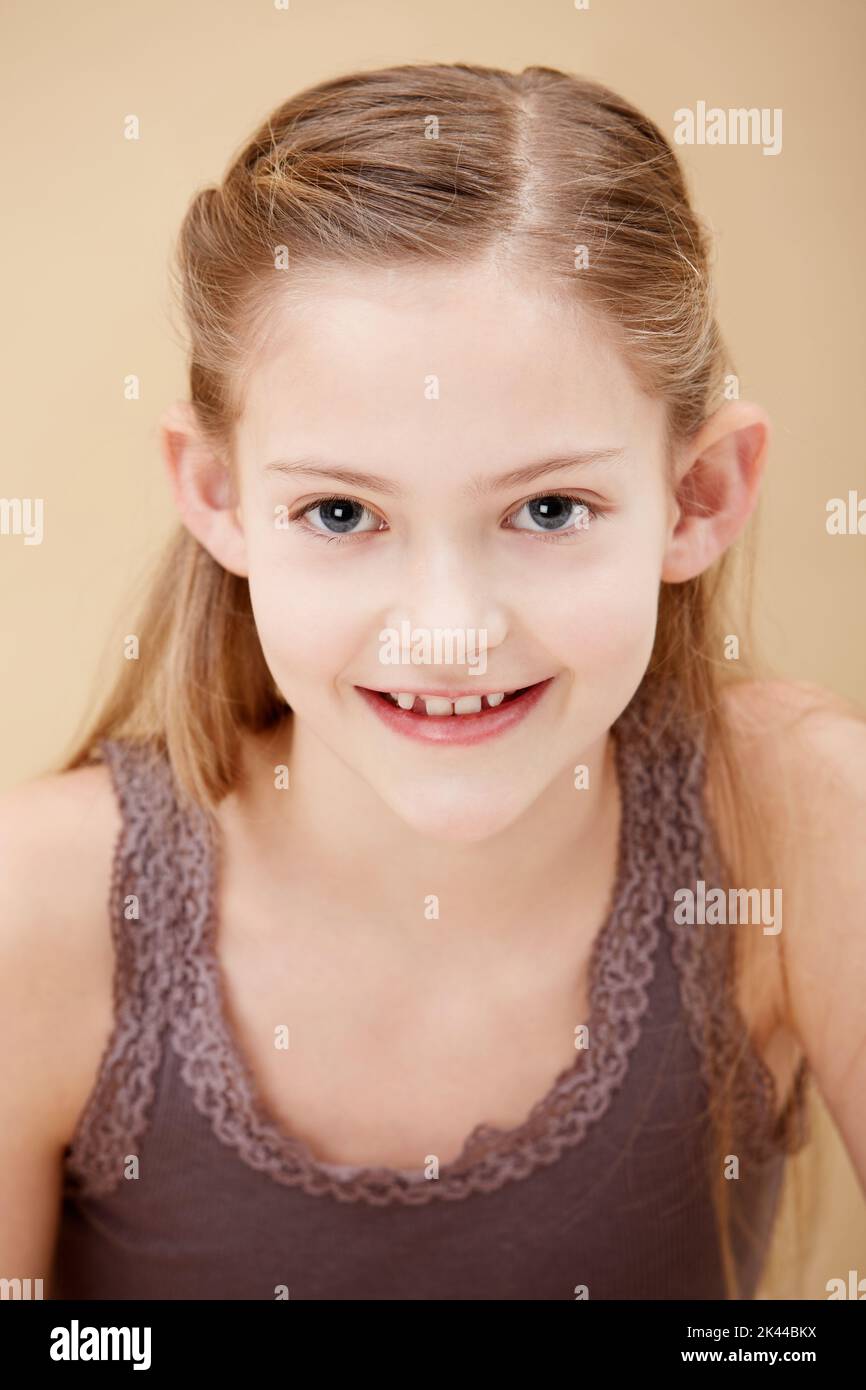Sweet and innocent. Cropped portrait of a cute little girl smiling ...