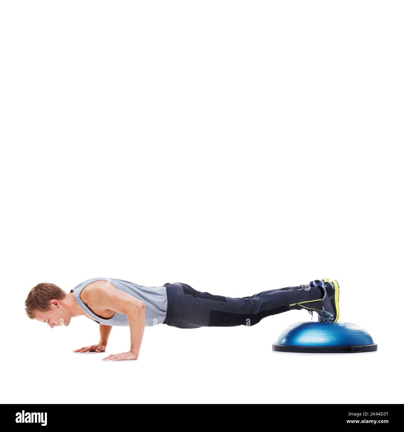 Hes following an effective workout plan. A young man doing push-ups on ...