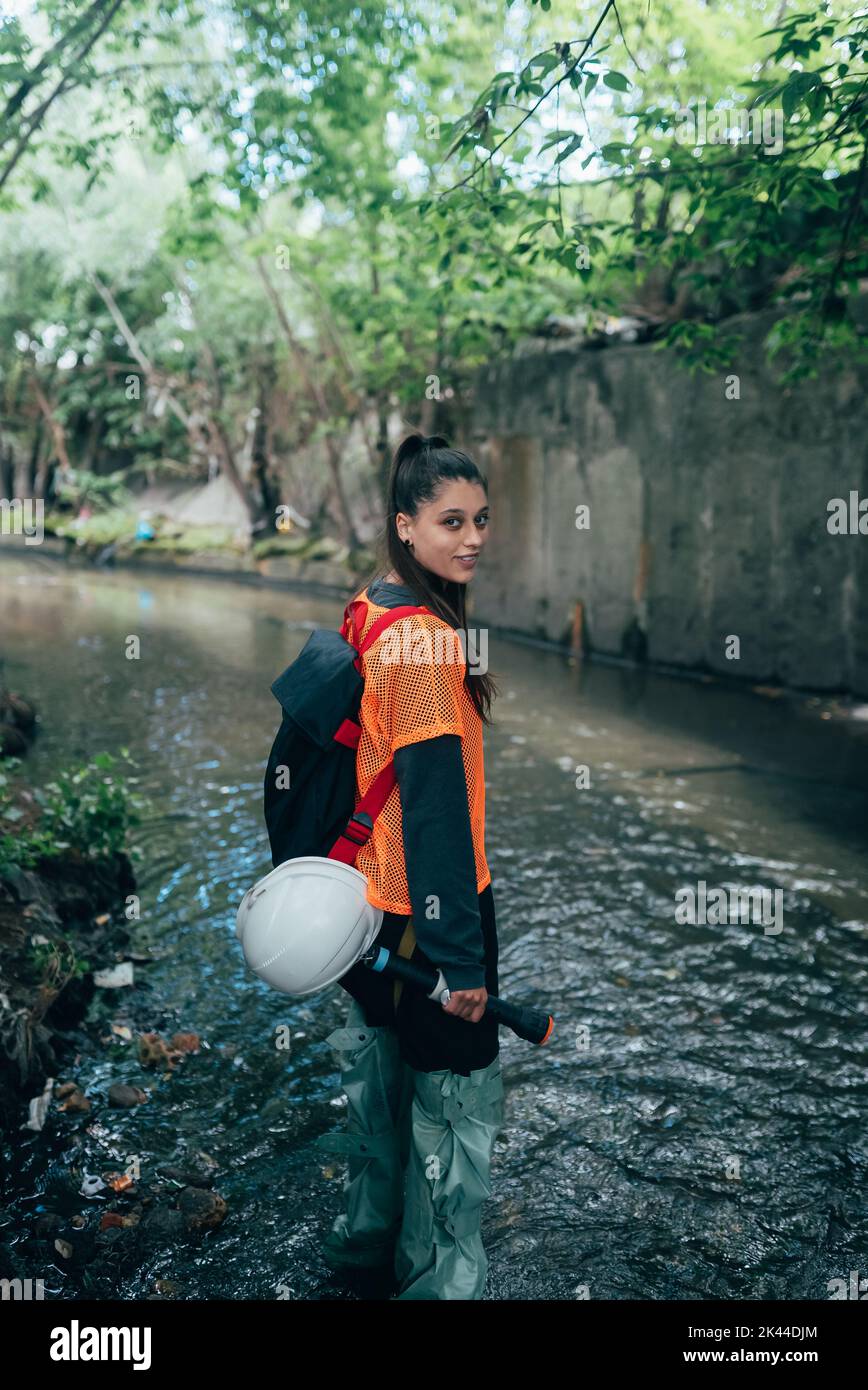 Young beautiful woman digger walks along the rain collector Stock Photo ...
