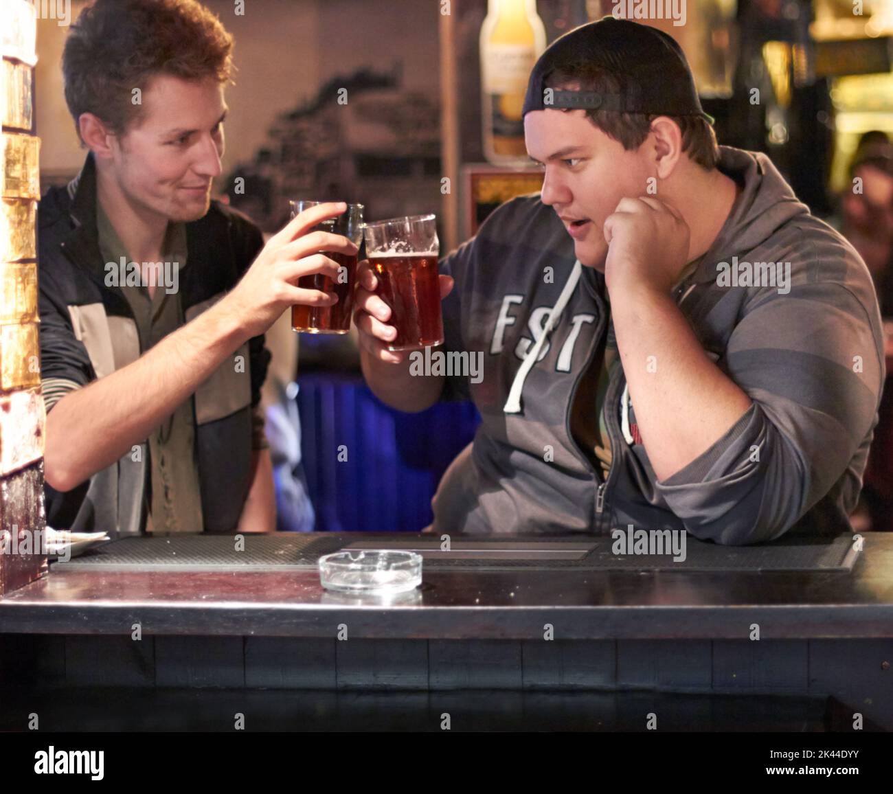 Having a pint with his pal. Two friends drinking at the local bar Stock ...
