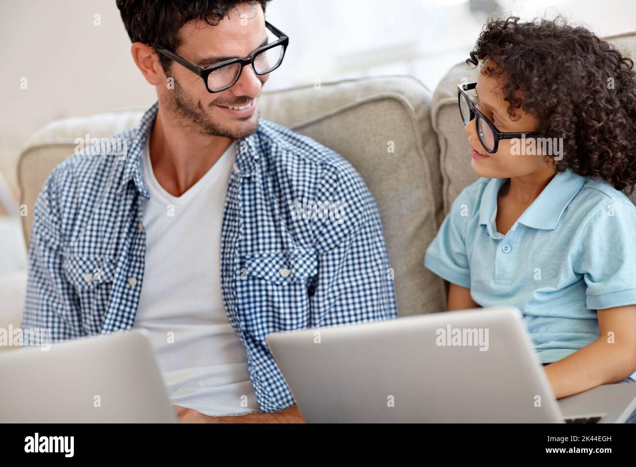 Showing Dad how its done. A little boy and his father working on ...