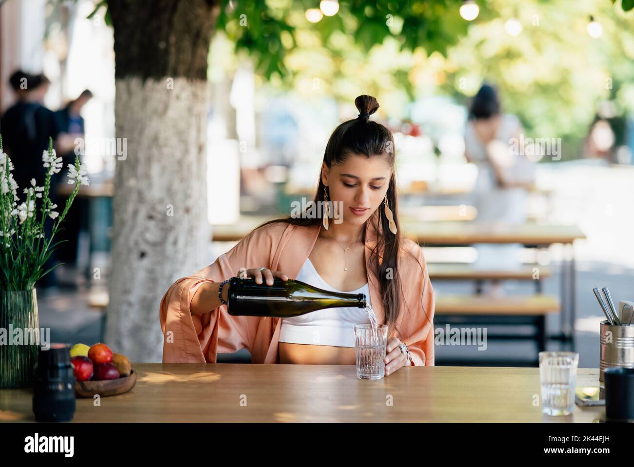 Young woman with a cold drink sitting in a cafe on the street Stock ...