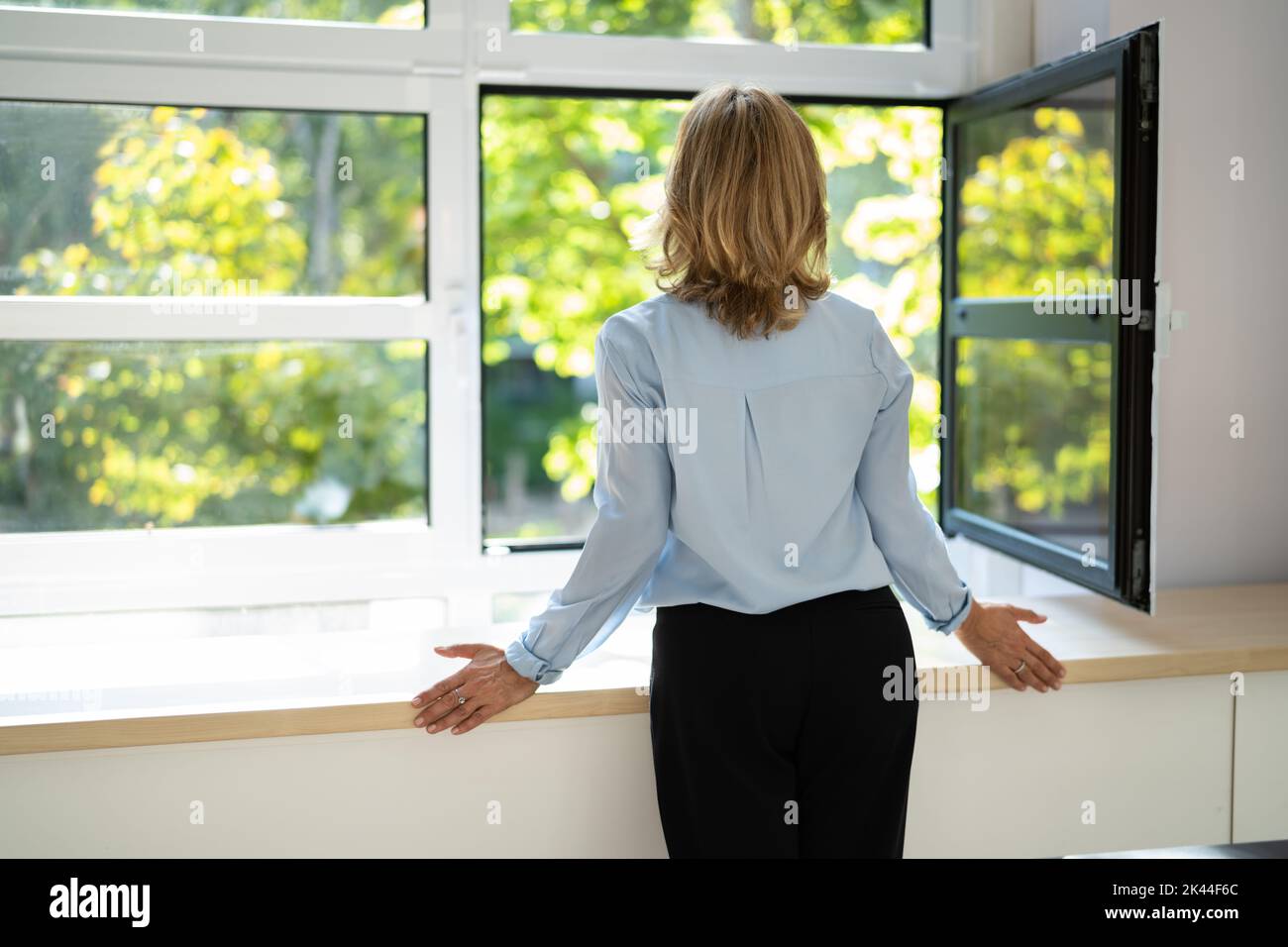 Fresh Air From Window. Rear View Of Woman Relaxing Stock Photo - Alamy
