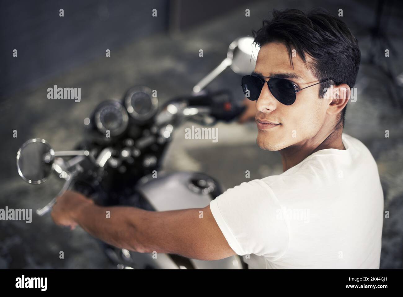 Its just us and the road. A handsome young man sitting on his ...