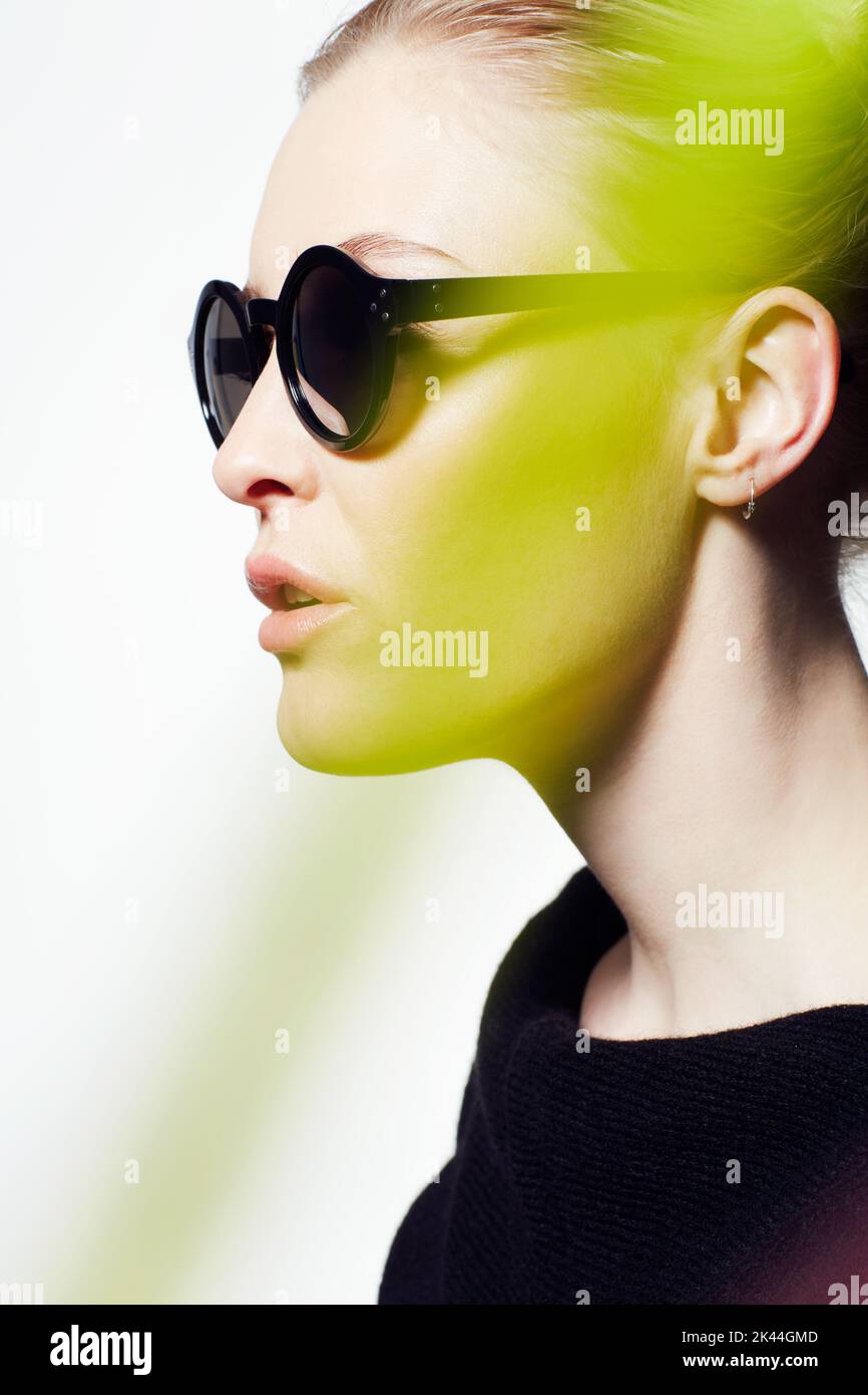 Light and style. Profile headshot of stylish model highlighted with ...