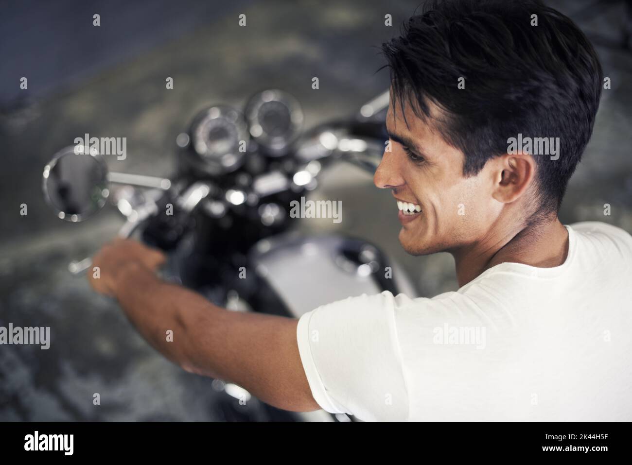 Loving every minute of his new lifestyle. A handsome young man sitting ...