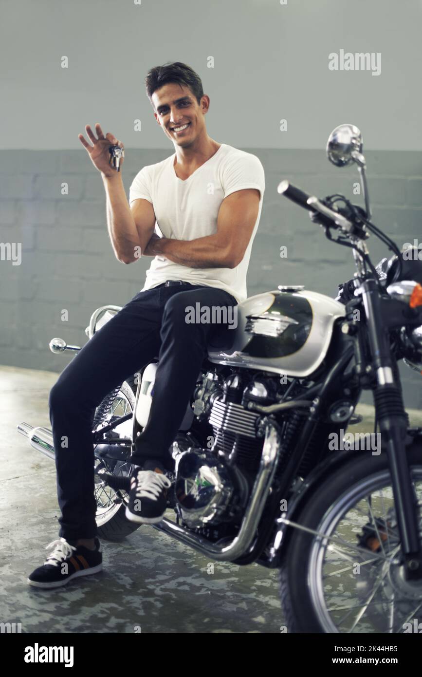 Ive got the keys to my freedom. A handsome young man sitting on his ...