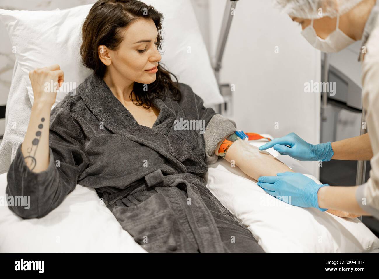 Woman with nurse during blood washing procedure at medical centre Stock ...