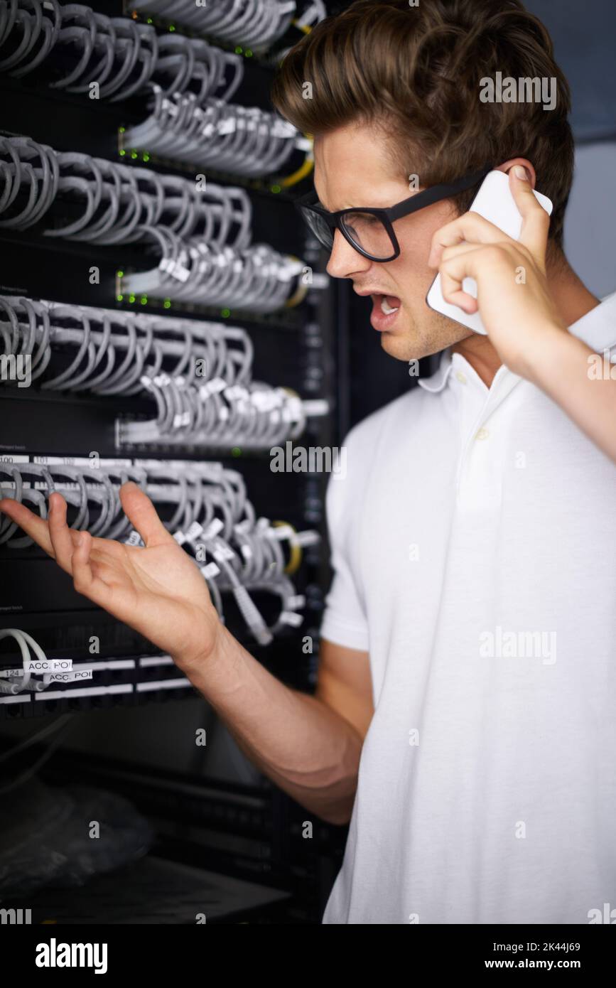 Taking care of your network needs. An angry technician talking on the ...