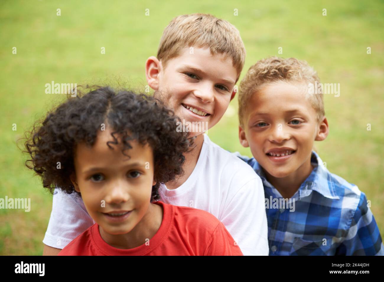 Life long friends. Portrait of three young kids standing outside Stock ...