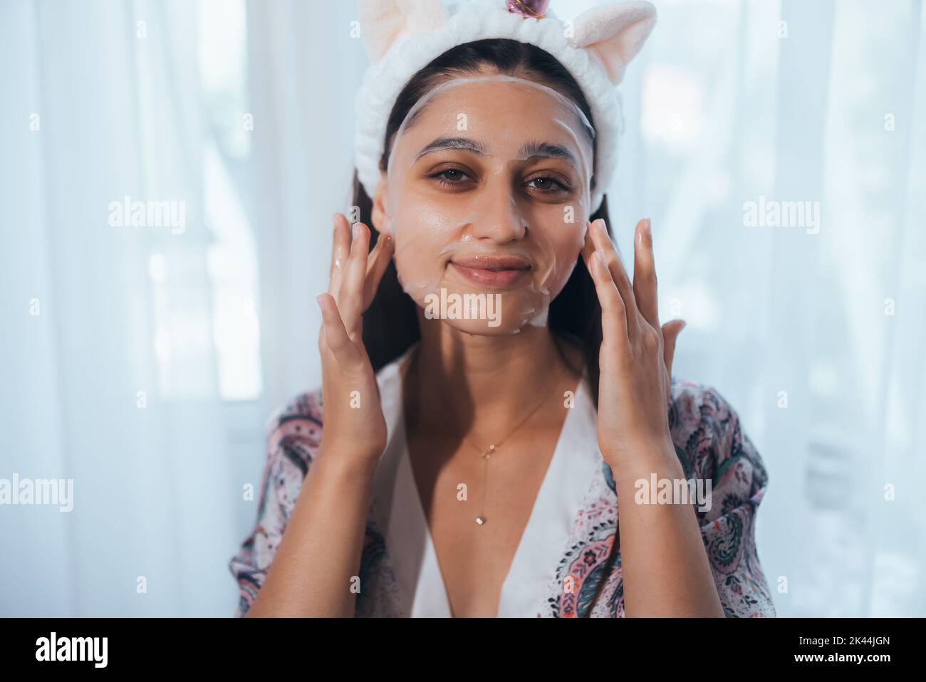 Beautiful model applying cosmetic cream treatment on her face Stock ...