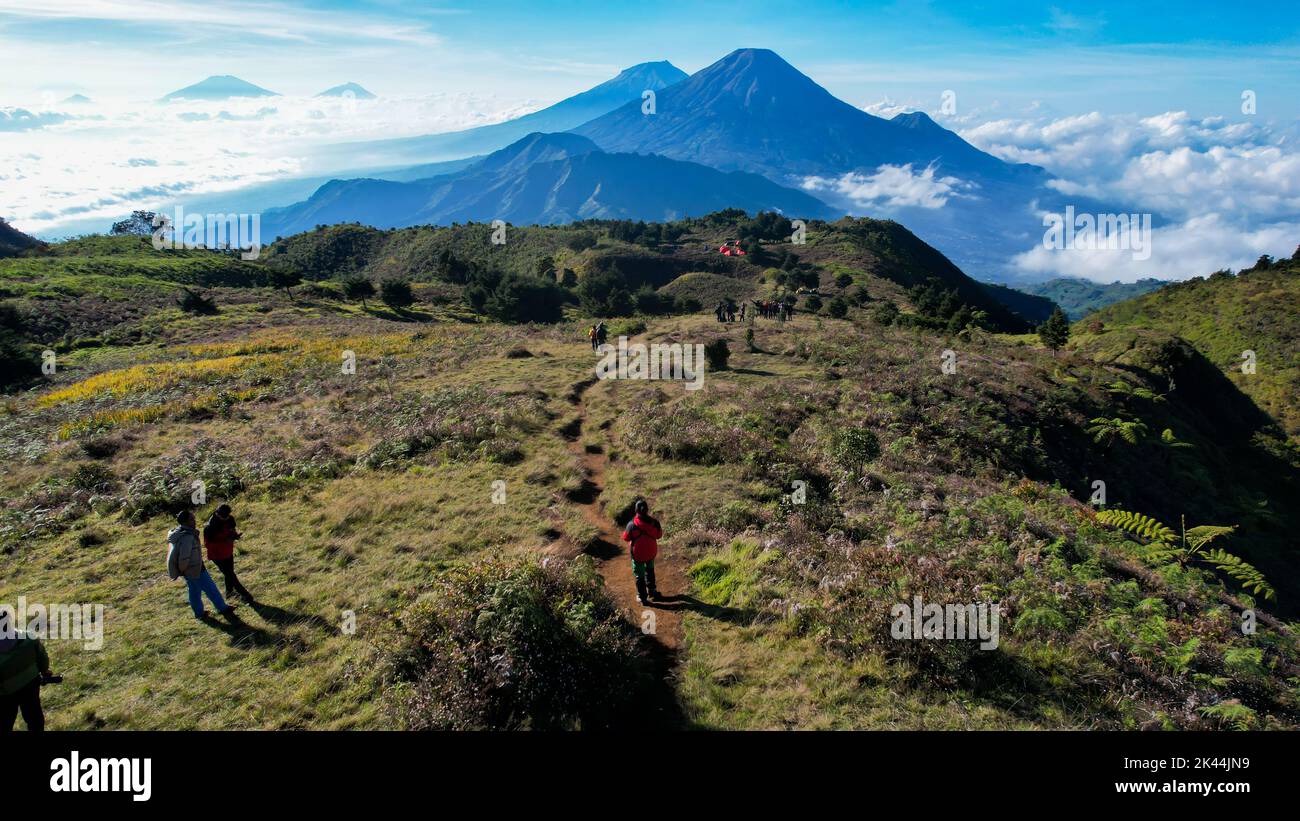 Aerial view of beauty mountain peaks Prau Dieng, Central Java and the climbers and tent ...