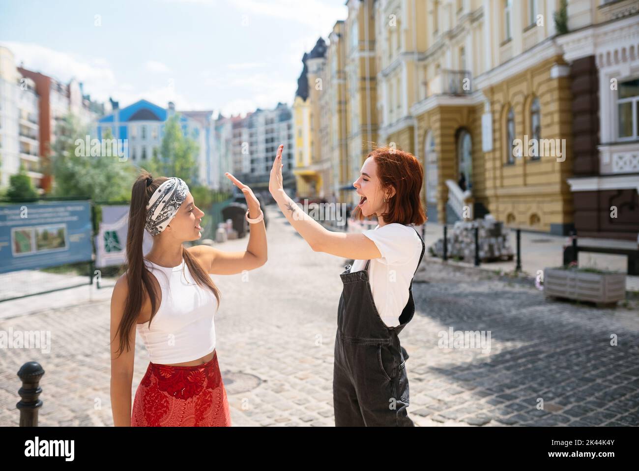 Two funny friends outdoors in the street Stock Photo - Alamy