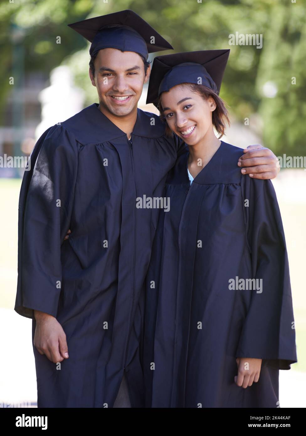 Ready for the future. Portrait of a smiling happy couple graduating ...