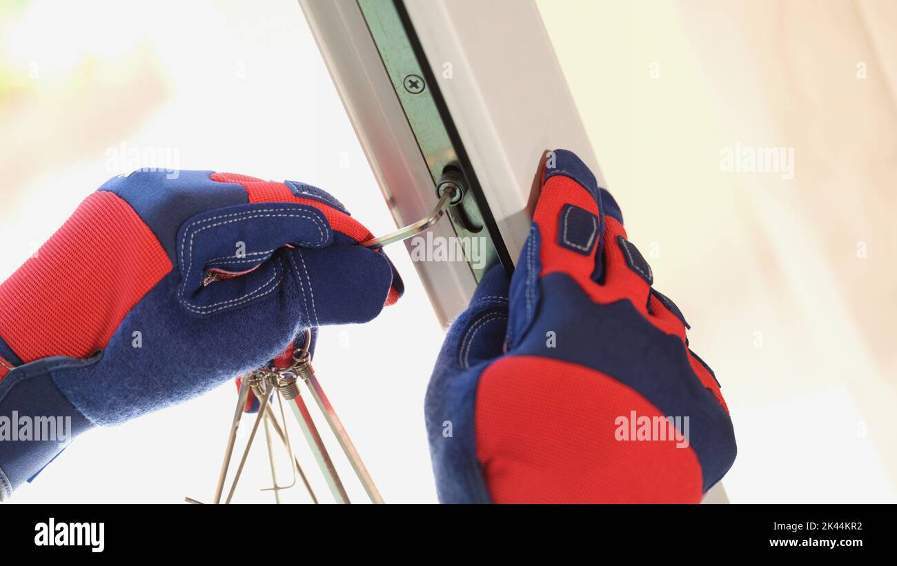 Hands of master with screwdriver repairing adjustment or installation ...