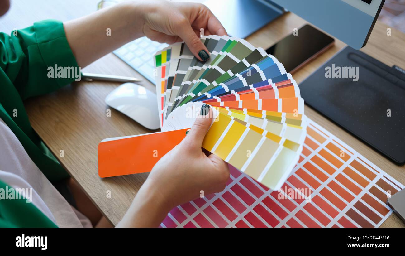 Designer shows color palette of samples of different colors and shades ...