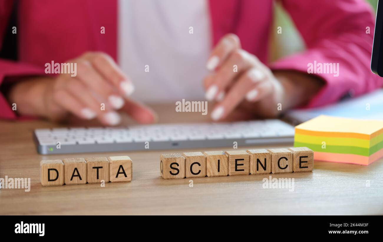 Hands typing on keyboard and data science text on cubes Stock Photo - Alamy