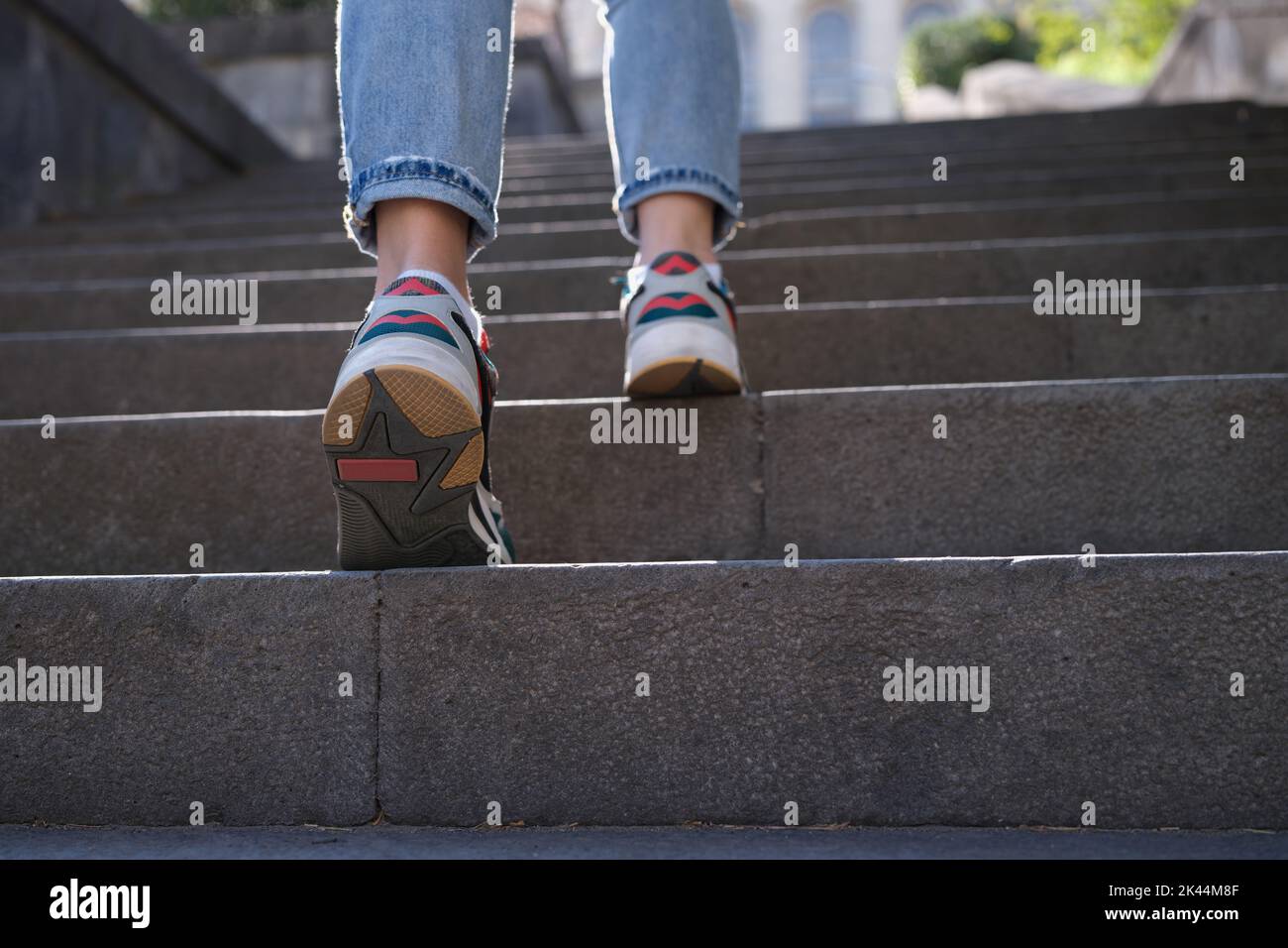 Woman walking up stairs success hi-res stock photography and images - Alamy