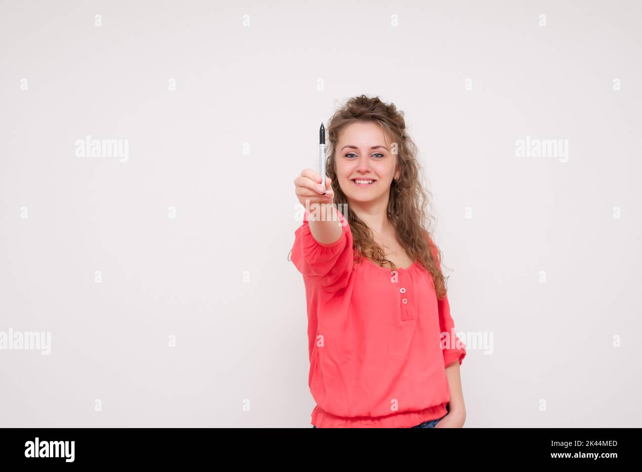 Happy smiling cheerful beautiful young business woman writing or ...