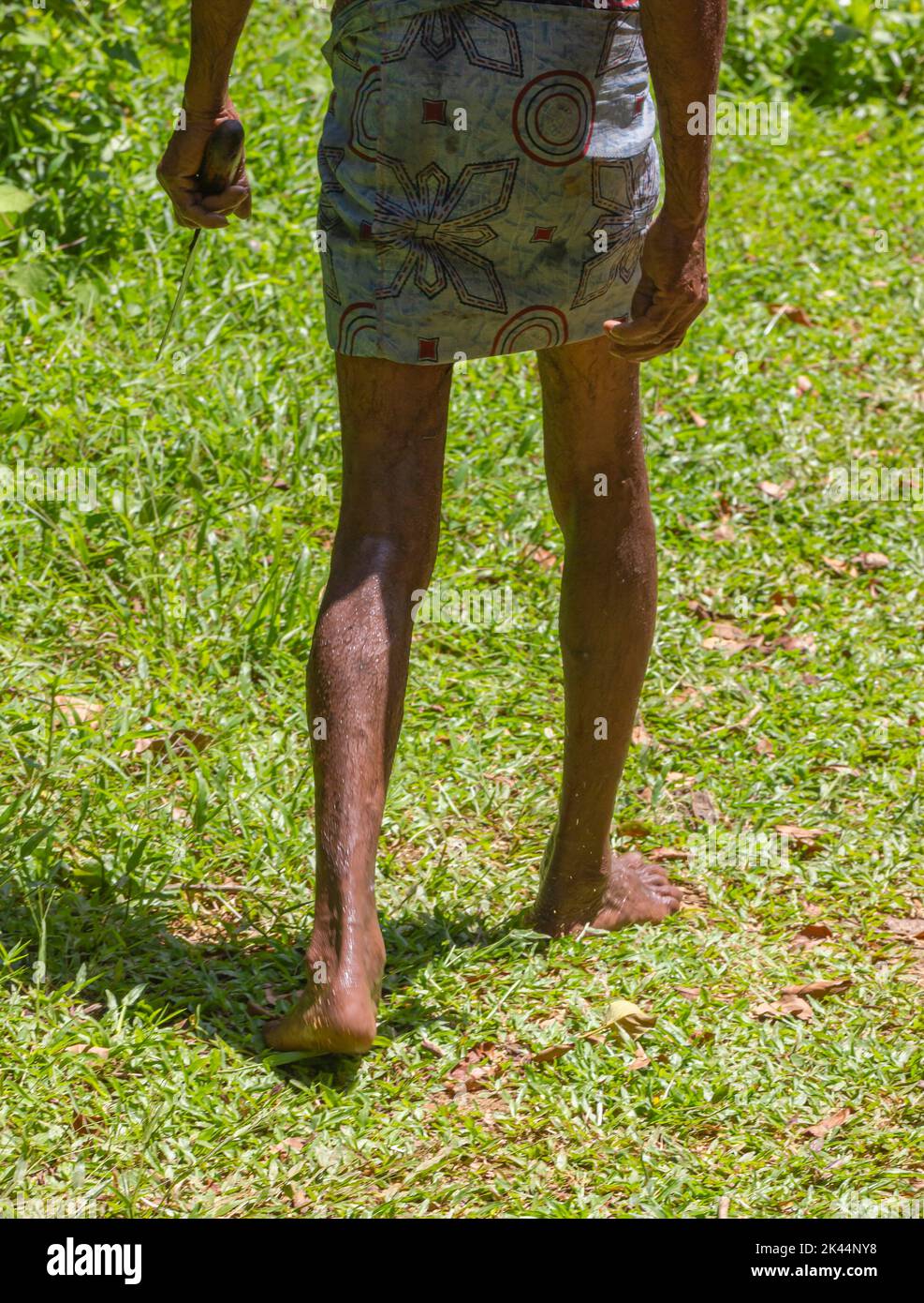 A man with his feet only showing walking in traditional village dress ...