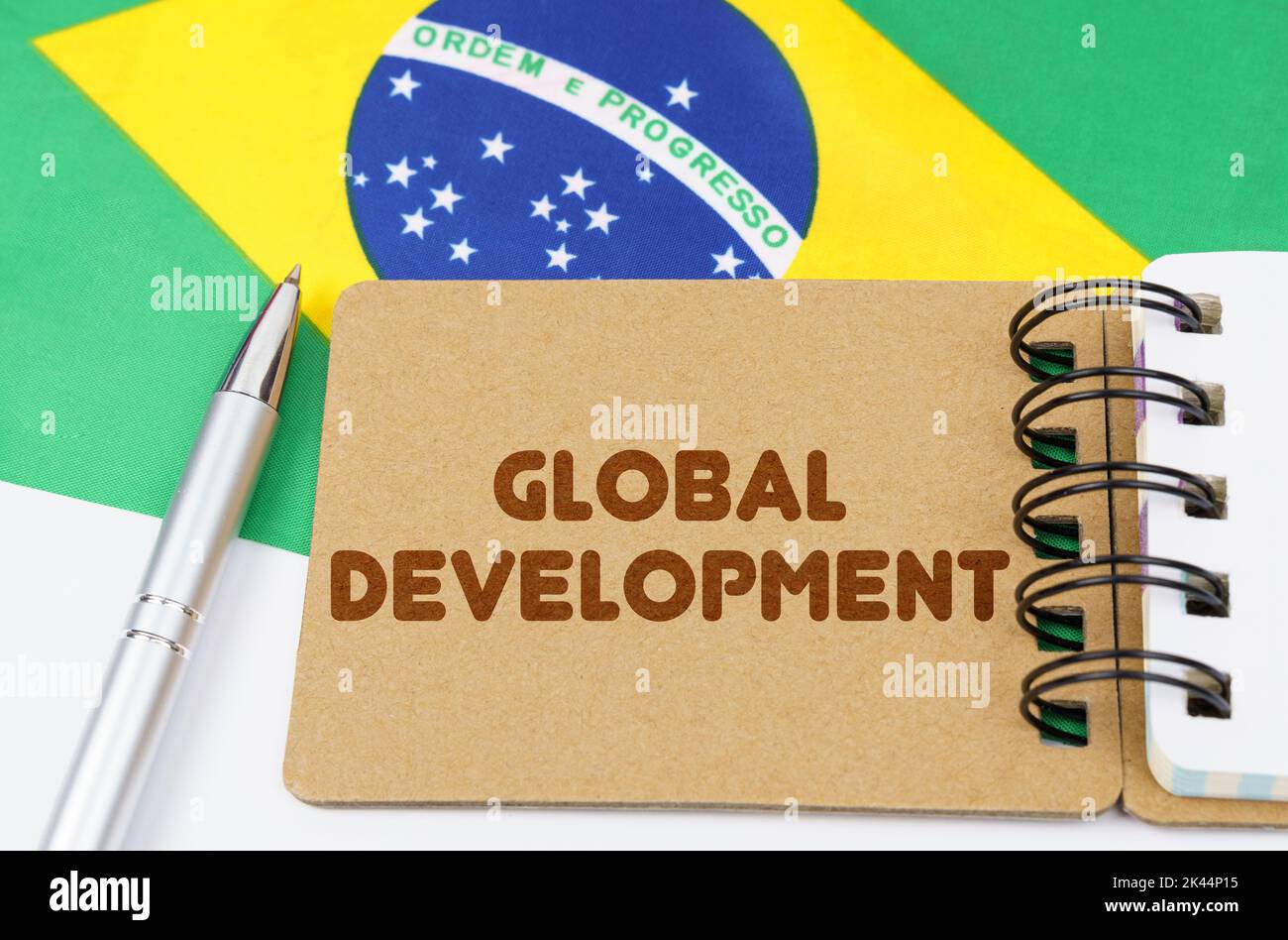 National economy concept. On the flag of Brazil lies a notebook with ...