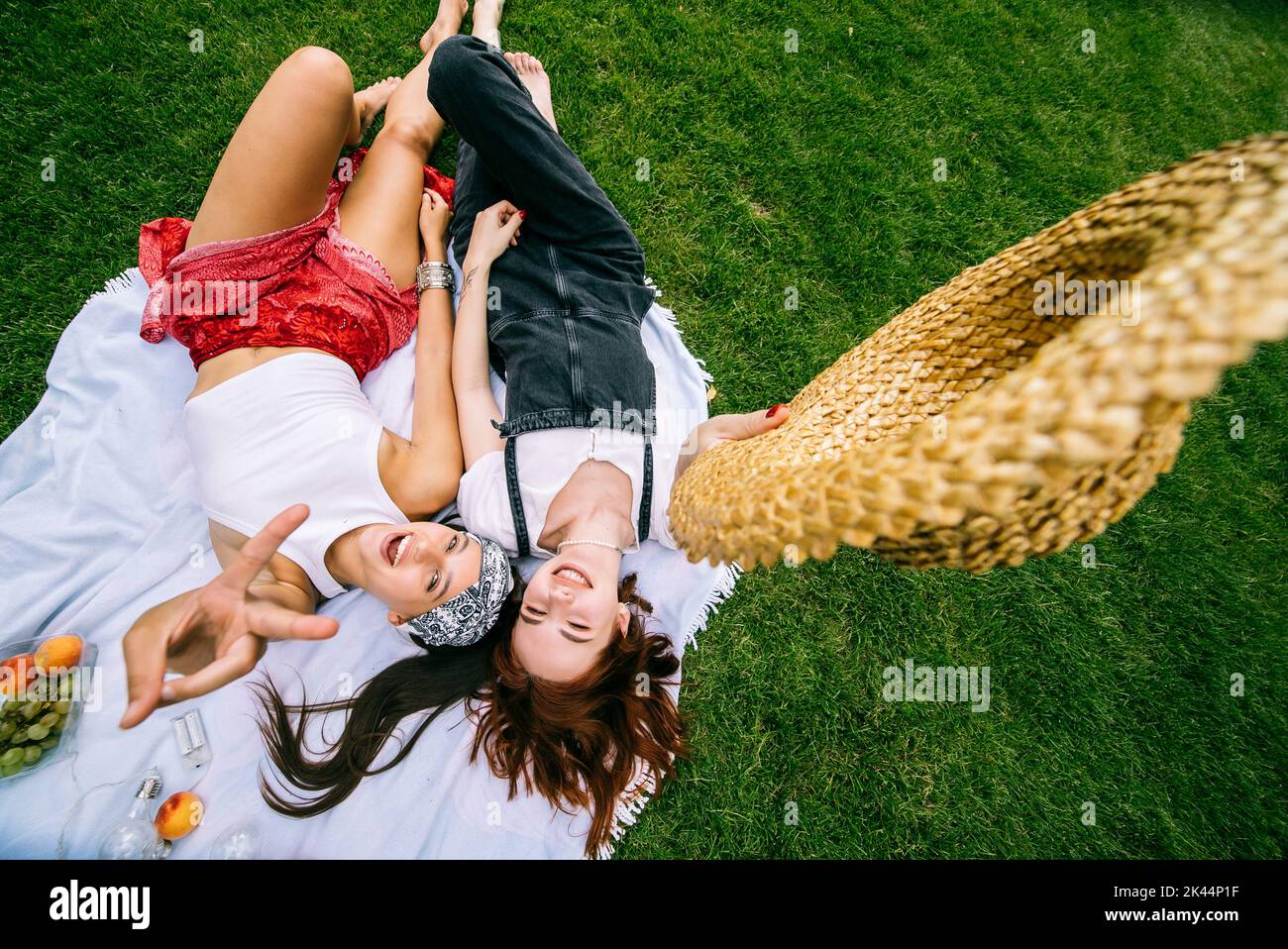 Top view, two young women lying in the park Stock Photo - Alamy