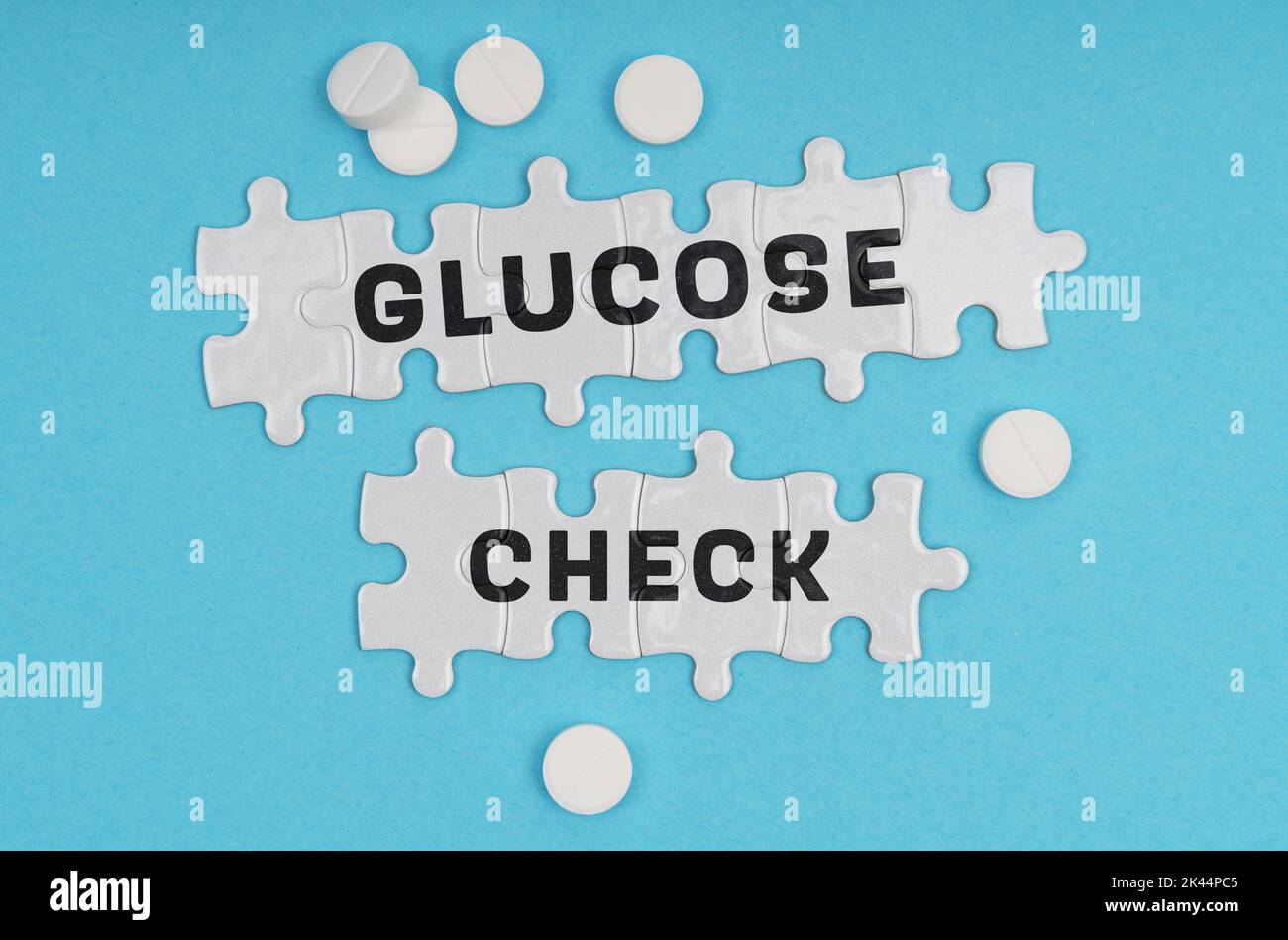 Medicine concept. On a blue background pills and puzzles with the ...