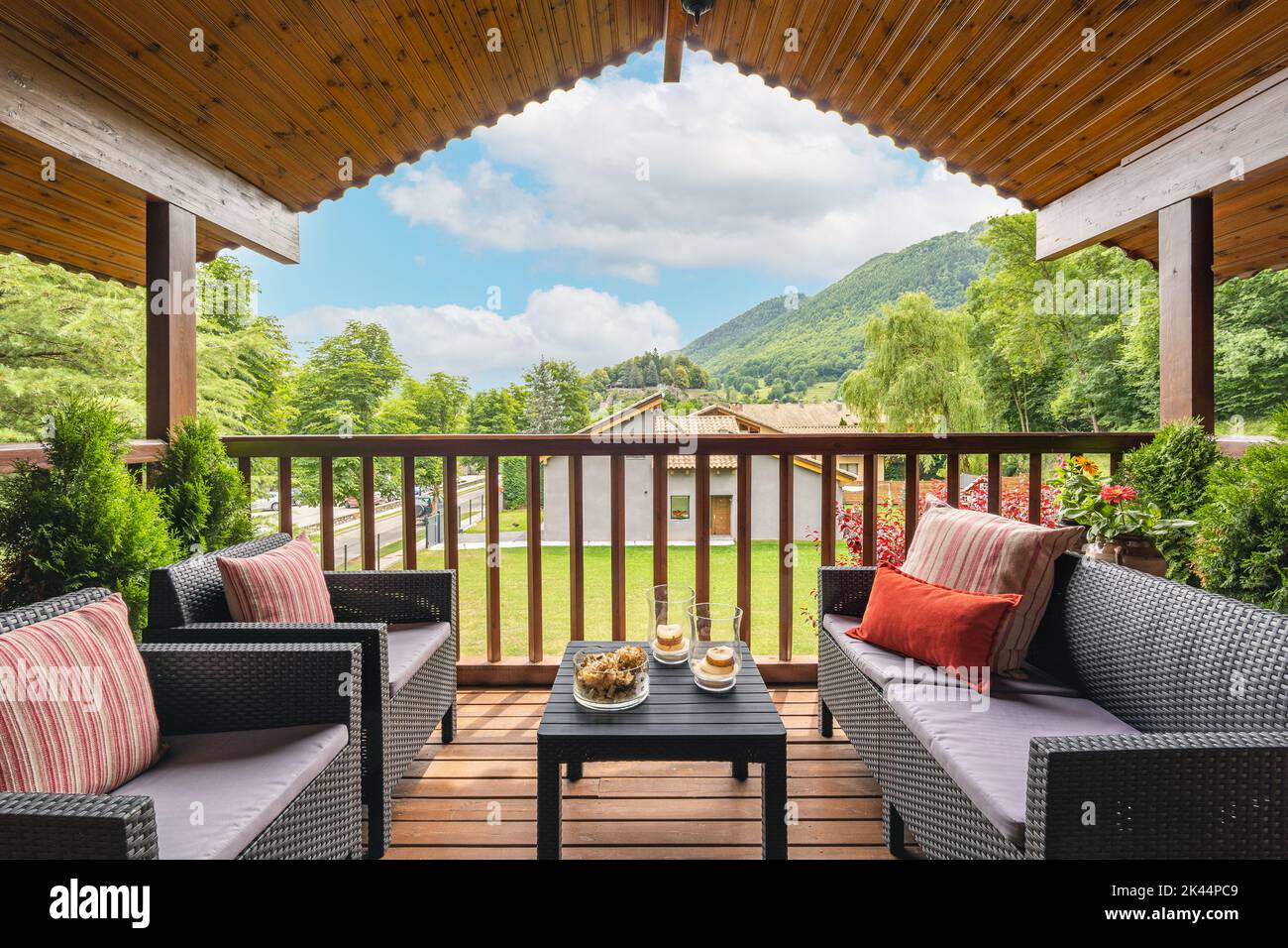 Beautiful view from a country house in the village. Terrace with chairs ...