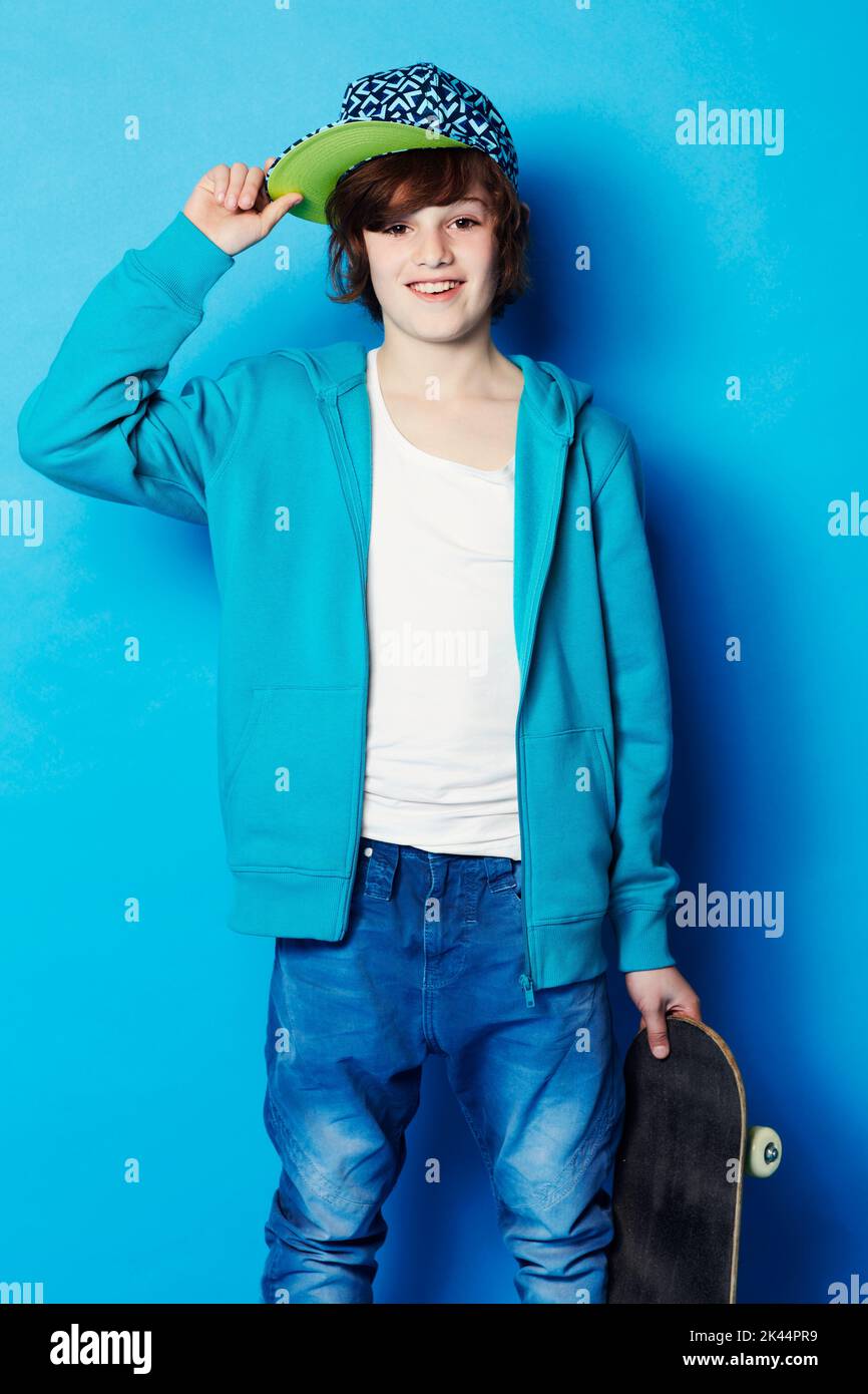 Hes a skater boy. Portrait of a young boy holding his skateboard Stock ...